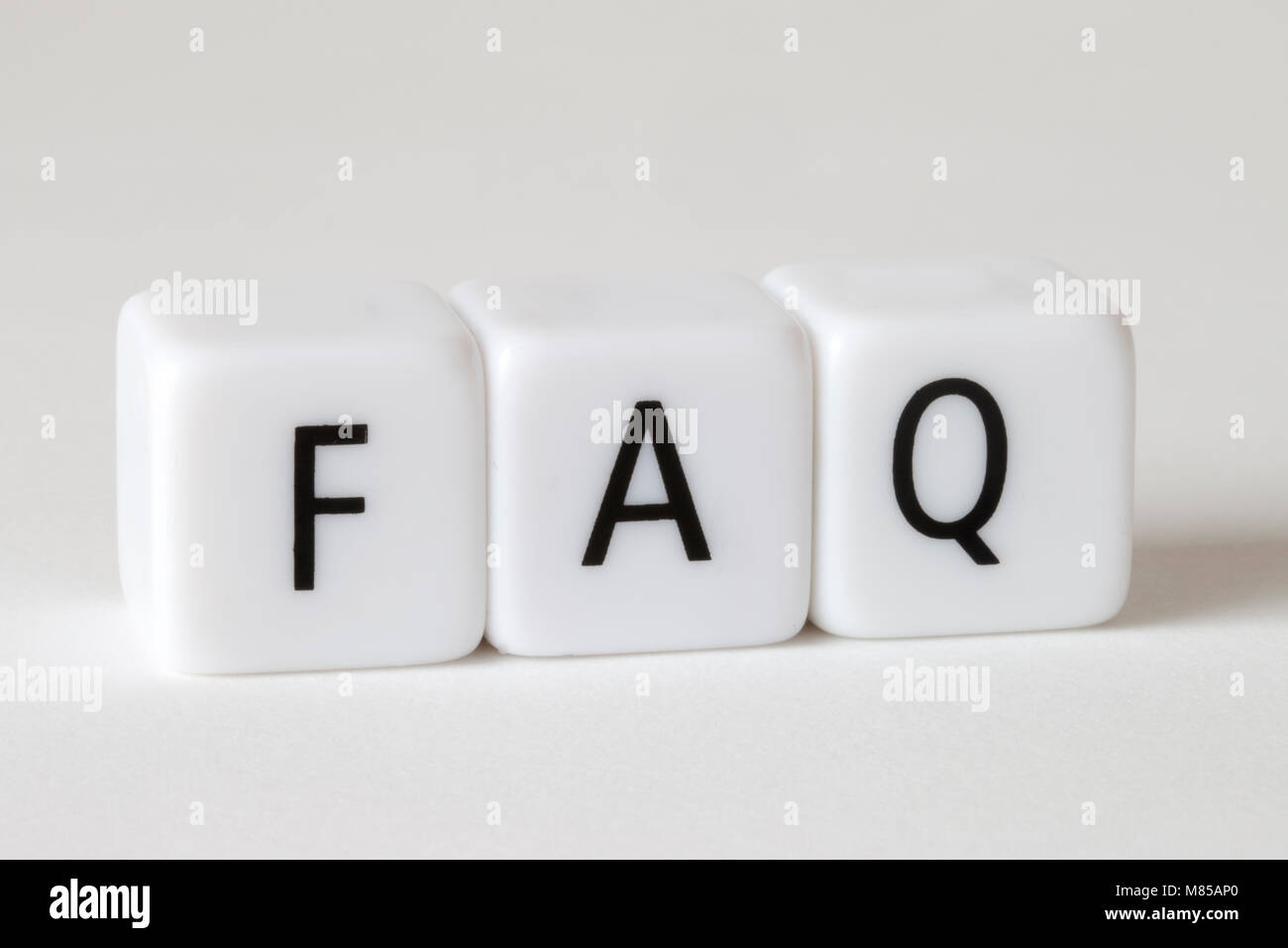 White cube written as FAQ Stock Photo - Alamy