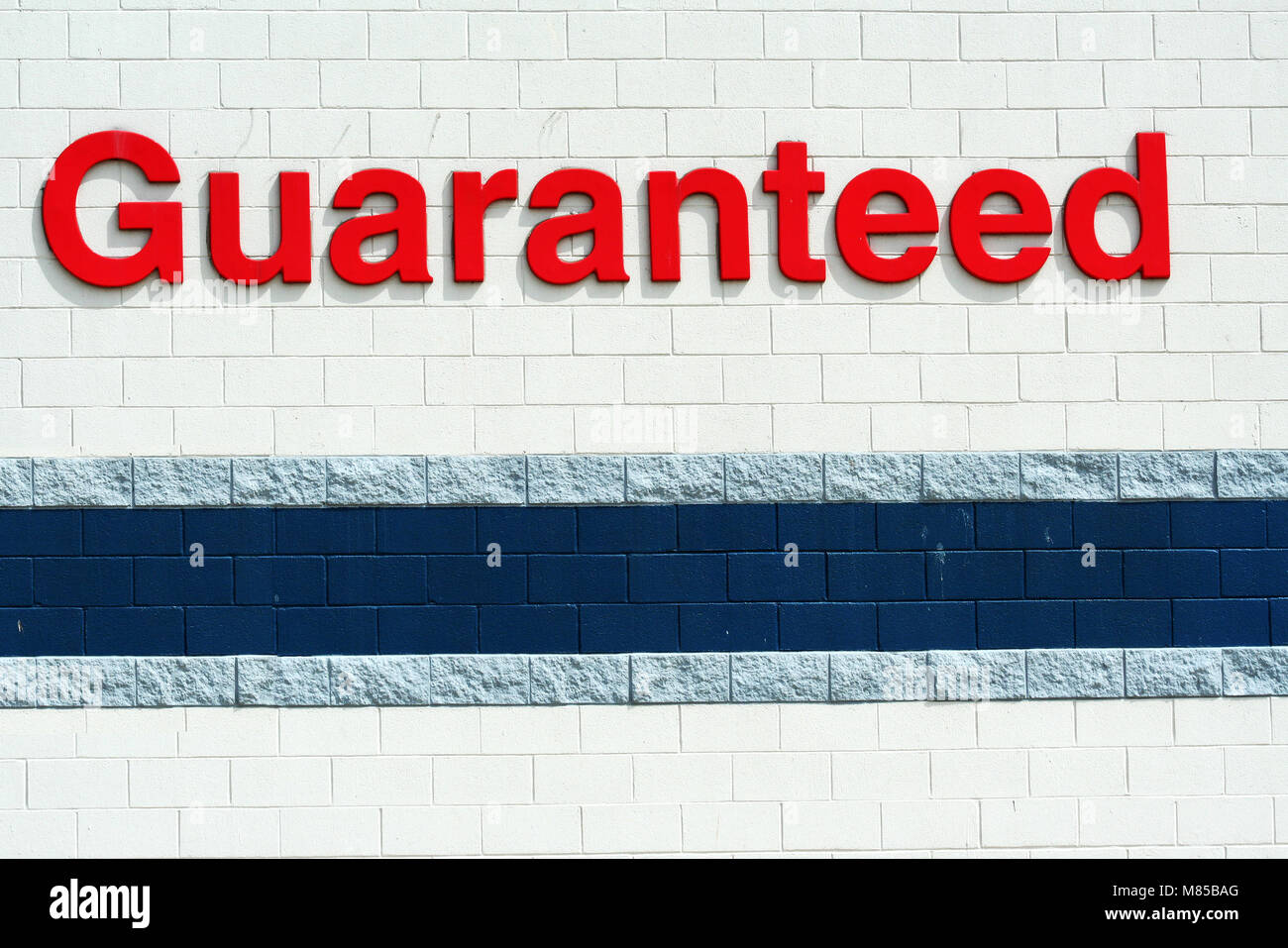 A Guaranted sign on a wall Stock Photo - Alamy