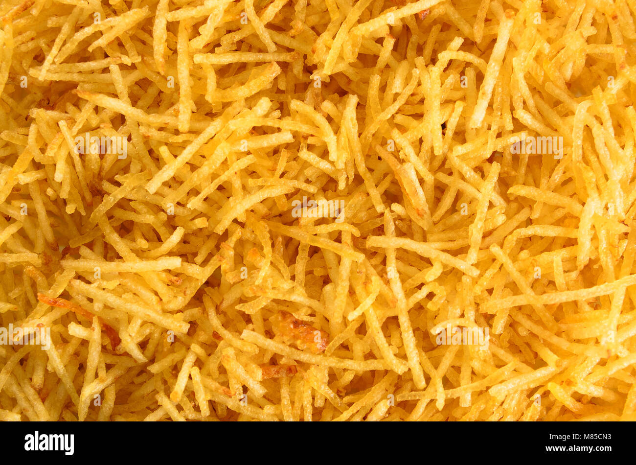 Texture of shoestring potato sticks. Fried potato, thin sticks. Also ...