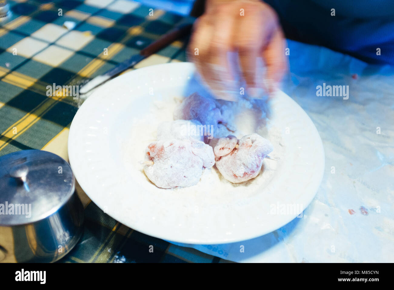 hands prepare pieces of meat, put into flour to be cooked,at home Stock ...