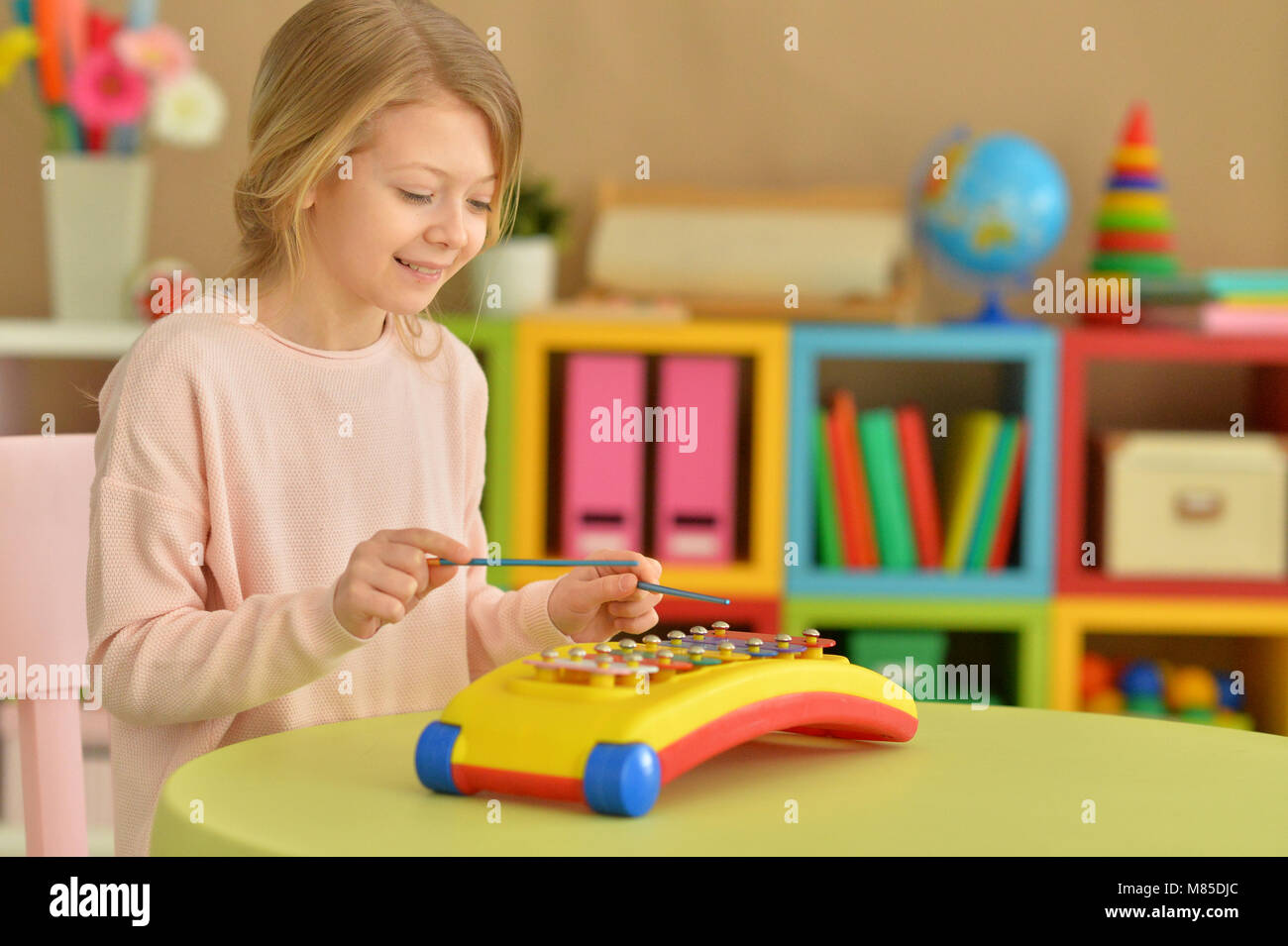 girl playing with musical toy Stock Photo - Alamy
