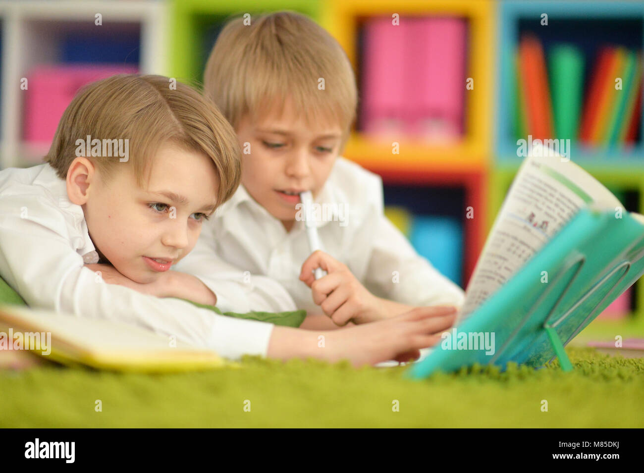 Two boys reading Stock Photo - Alamy