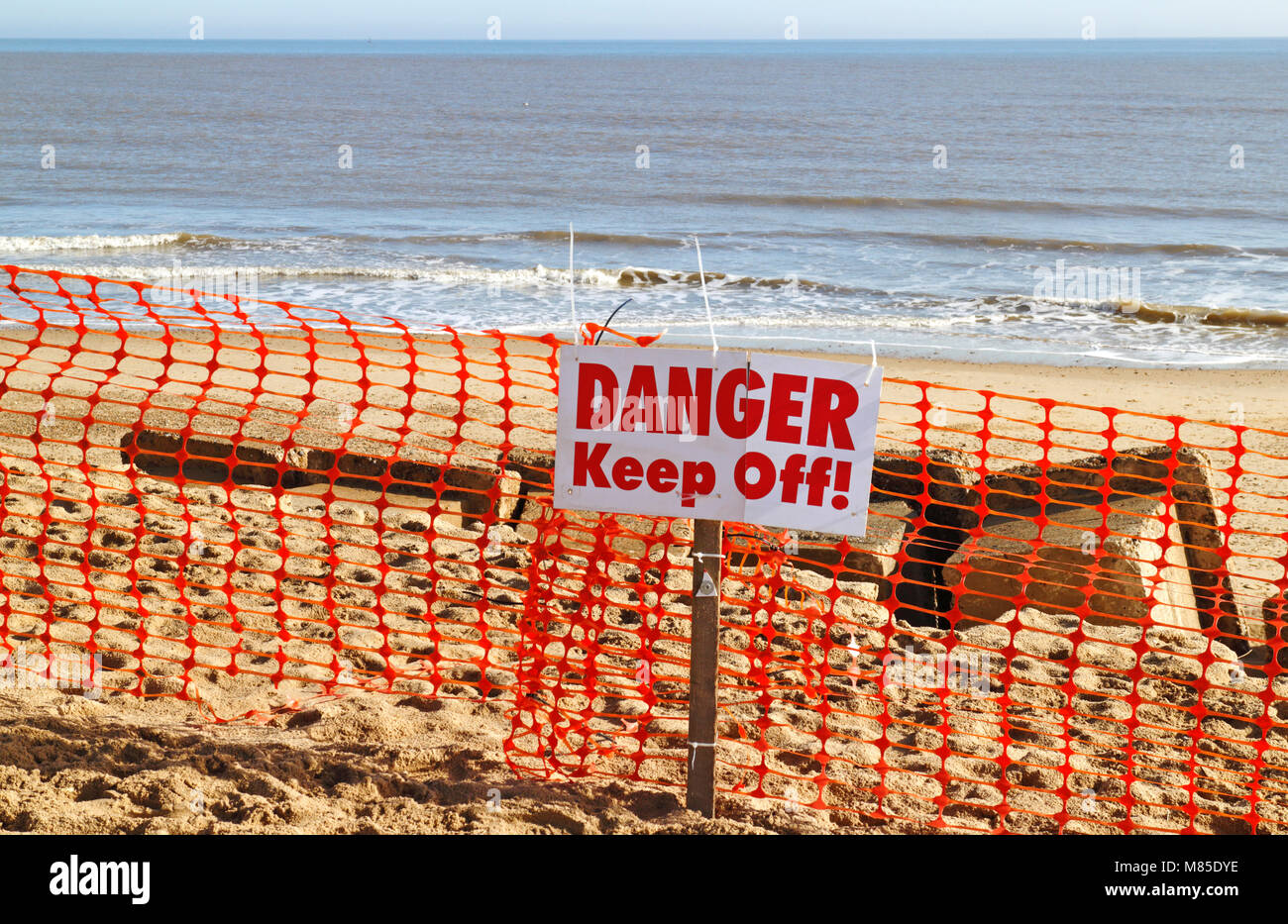A view of a Danger Keep Off sign by eroded sands on the East Norfolk ...