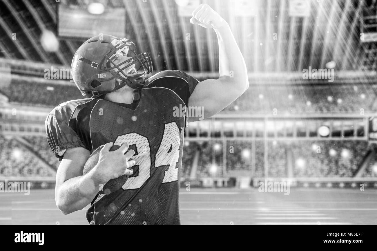 american football player celebrating touchdown on big modern stadium ...