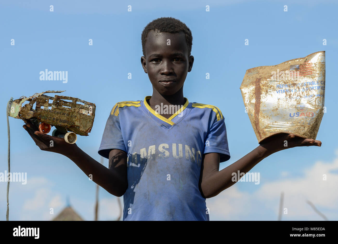 ETHIOPIA Gambela, Nuer village, toy car made from US AID oil can ...