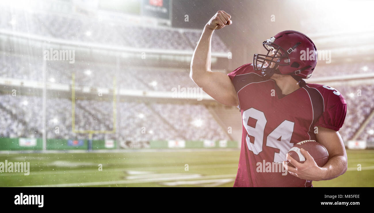 american football player celebrating touchdown on big modern stadium ...