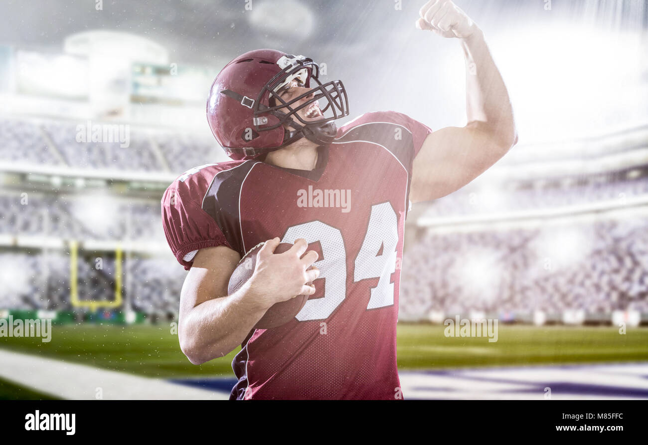 american football player celebrating touchdown on big modern stadium ...