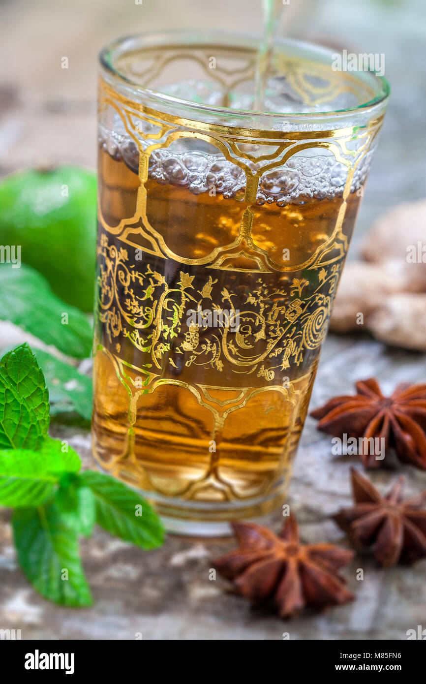 Arabic nana mint tea in traditional glass with mint, cinnamon, anise ...
