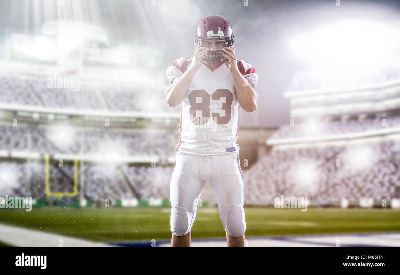 American Football Player isolated on big modern stadium field with ...