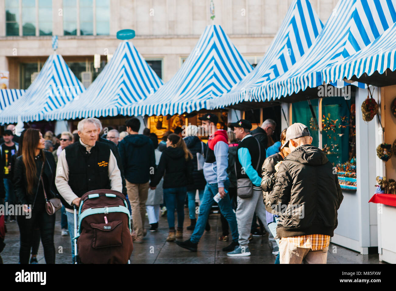 Celebrating the Oktoberfest. People walk on the street market on the ...