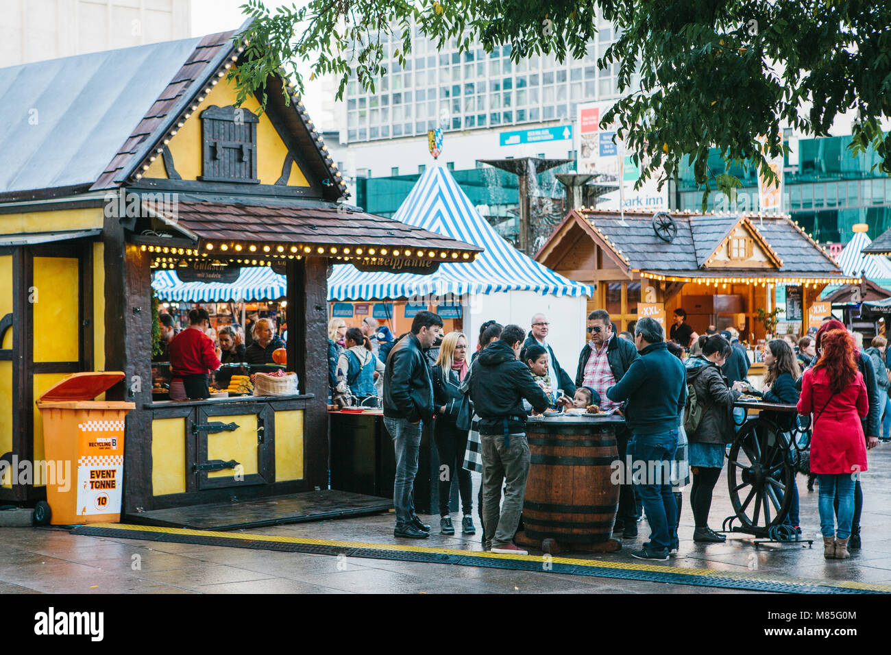 Celebrating the Oktoberfest. People walk on the street market on the ...