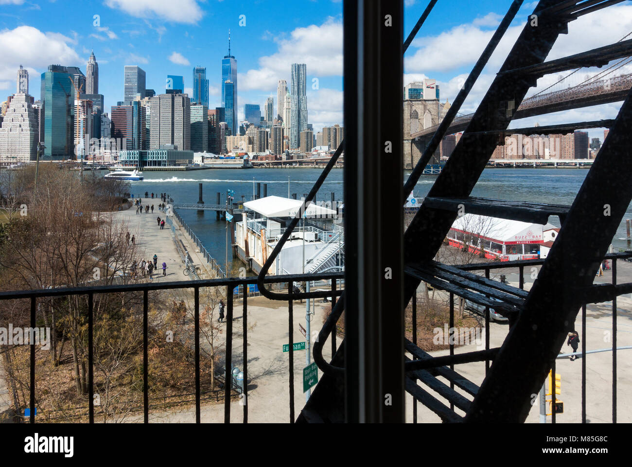 View of Lower Manhattan skyline and Dumbo ferry station on a sunny ...
