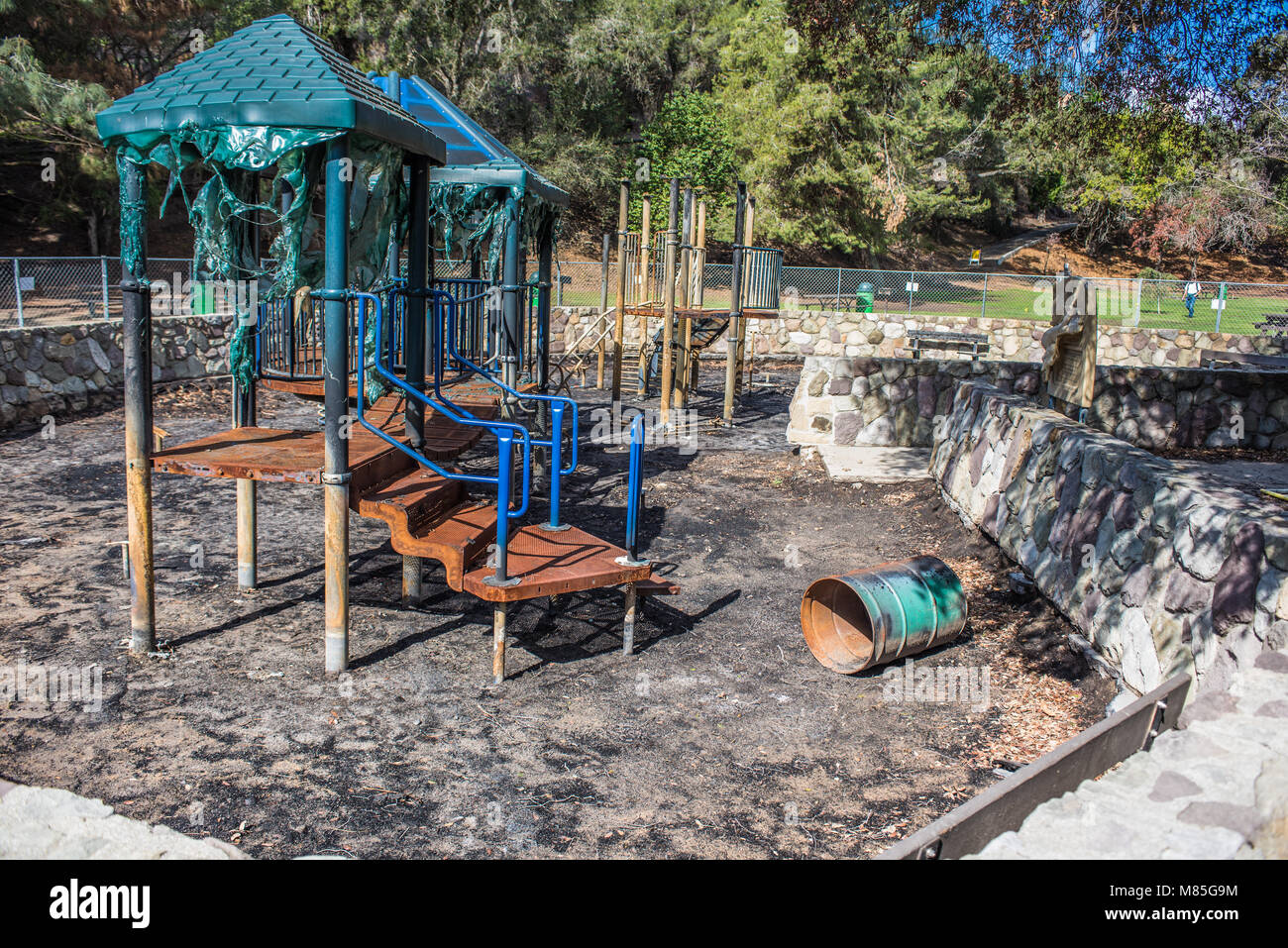Burnt playground equipment is melted and full of charred ash after the ...