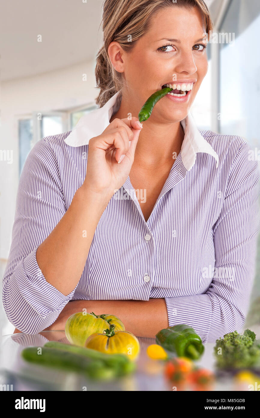Beautiful woman eating chilli hi-res stock photography and images - Alamy