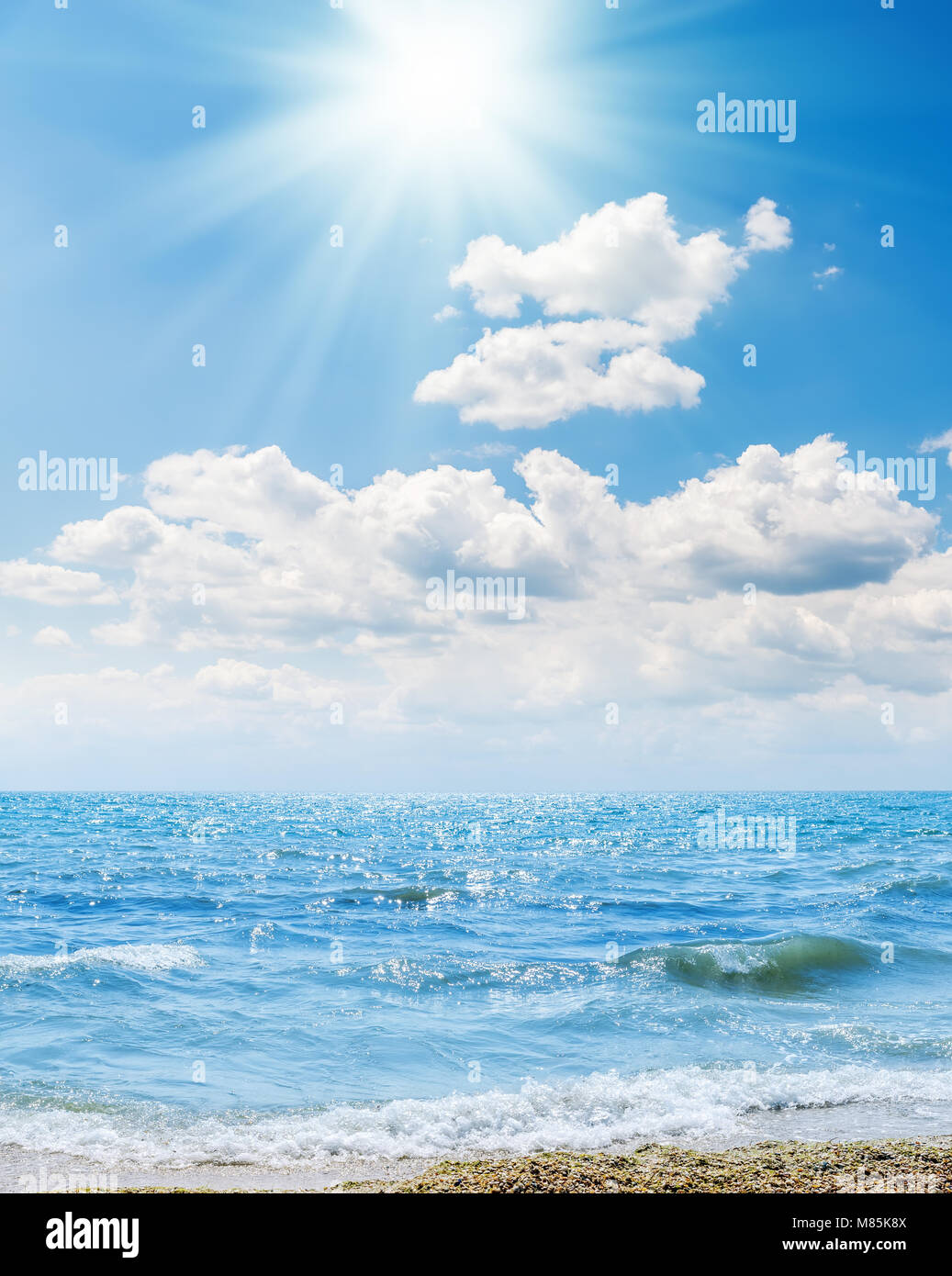 sea with blue water on beach and clouds in blue sky with sun Stock ...