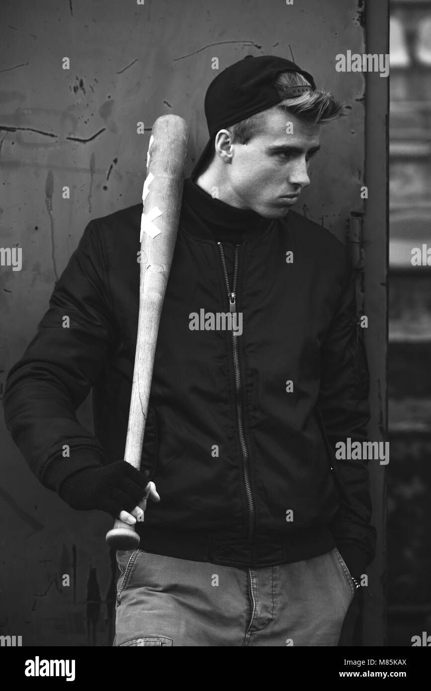 Aggressive blond haired hooligan with baseball bat with nice hairstyle ...