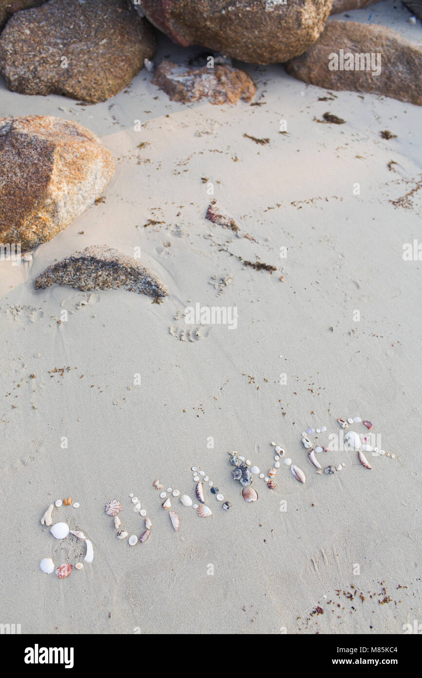 The word summer, written with shells in the sand on a beach in thailand ...