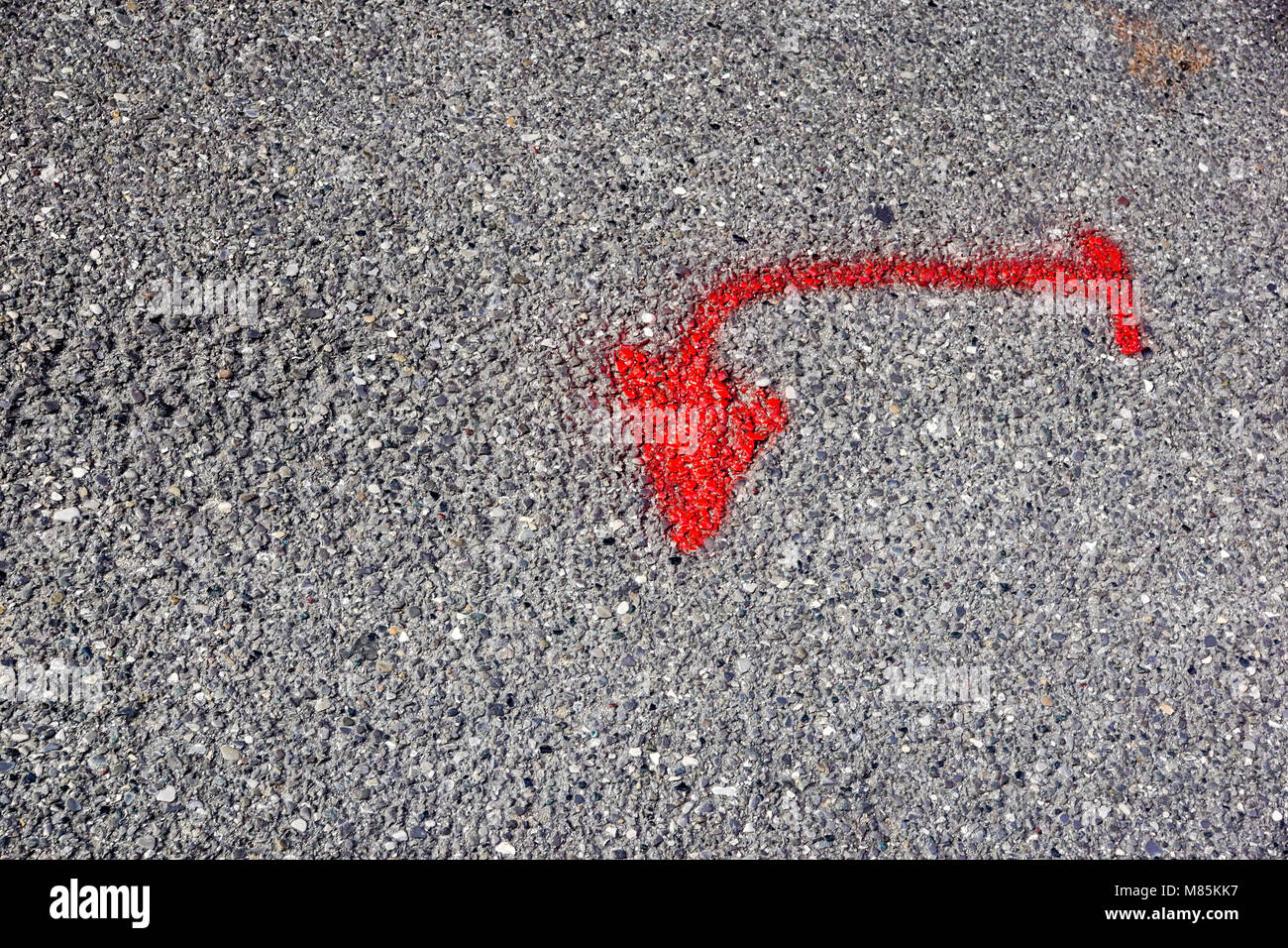 red arrow on road asphalt pointing up weathered Stock Photo - Alamy