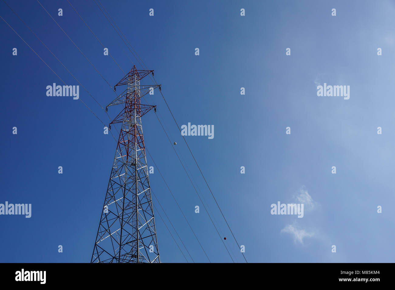 High Voltage Power Lines intersect at a large metal Utility pole in ...