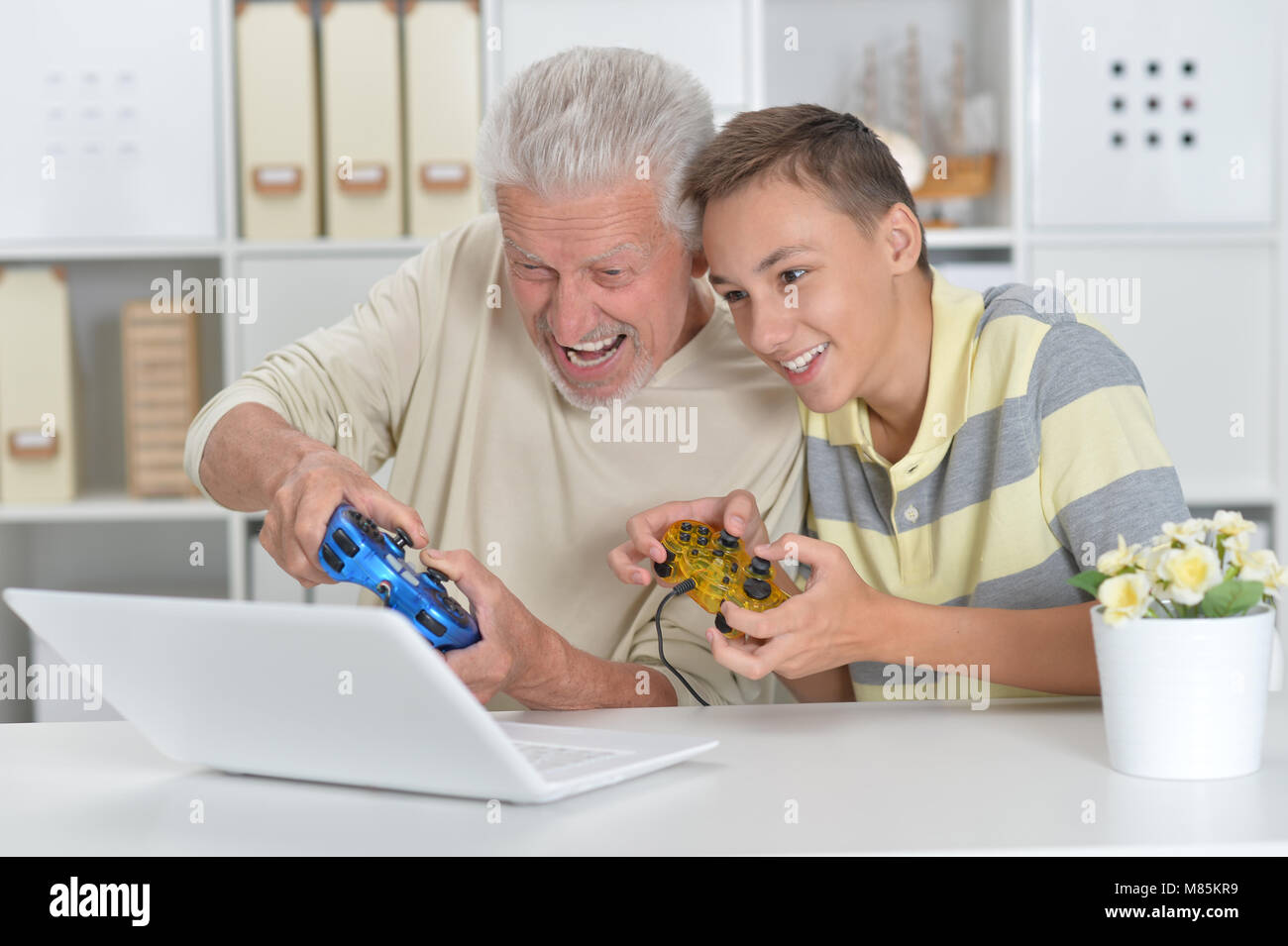 boy and grandfather playing computer game Stock Photo - Alamy