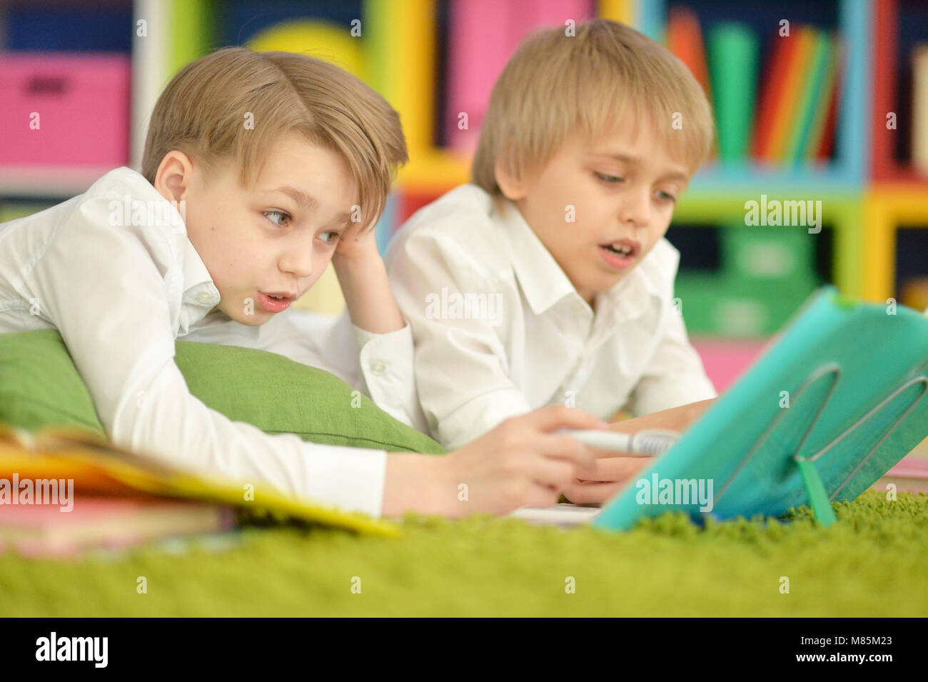 Two boys reading Stock Photo - Alamy