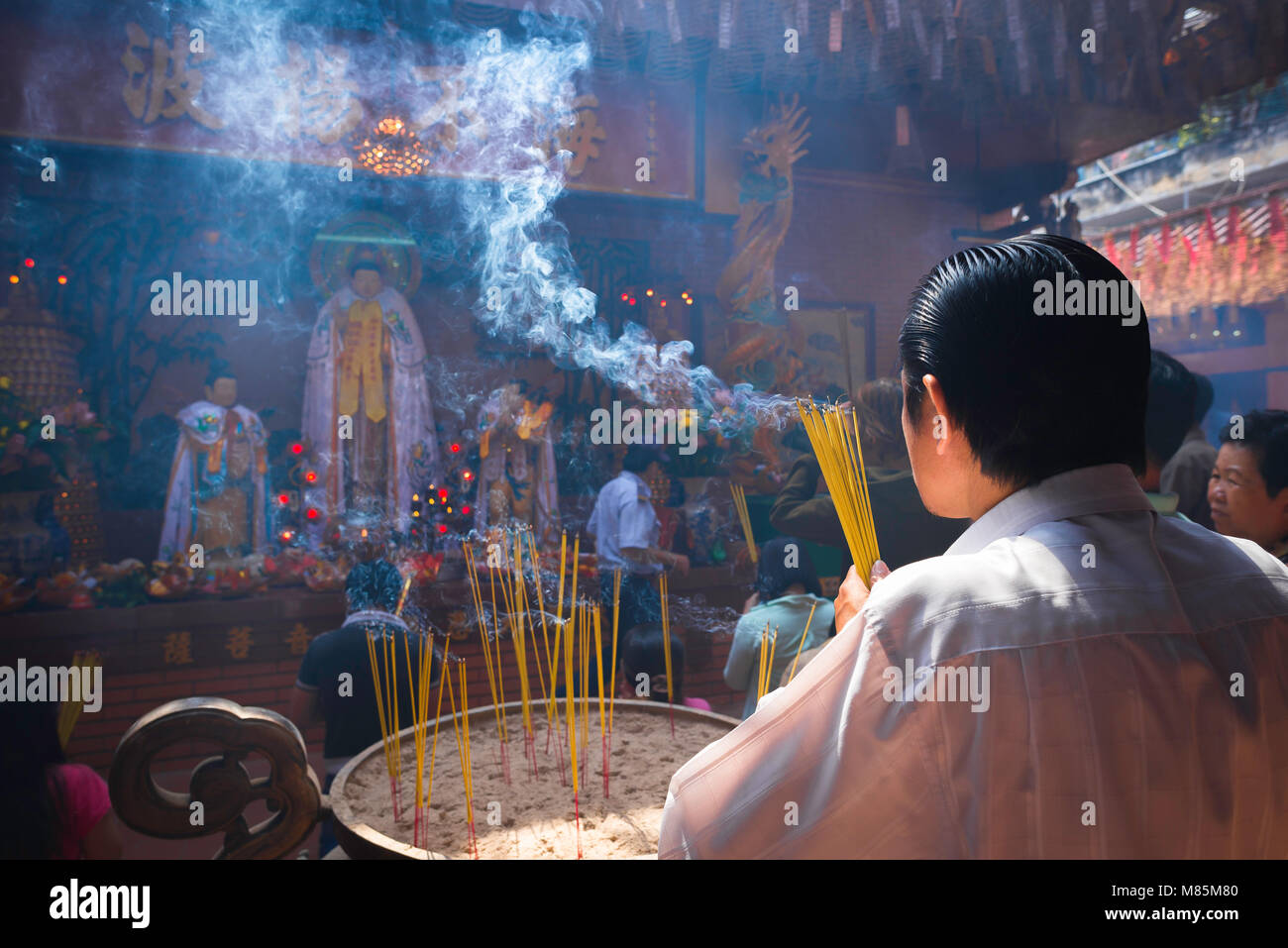 Man prayer Southeast Asia, rear view of a man praying in the Quan Am ...