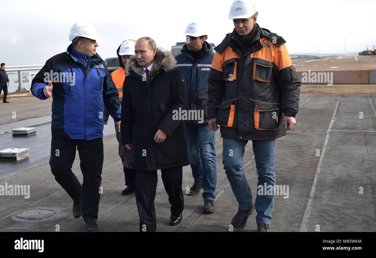 Russian President Vladimir Putin talks with workers during a tour of ...