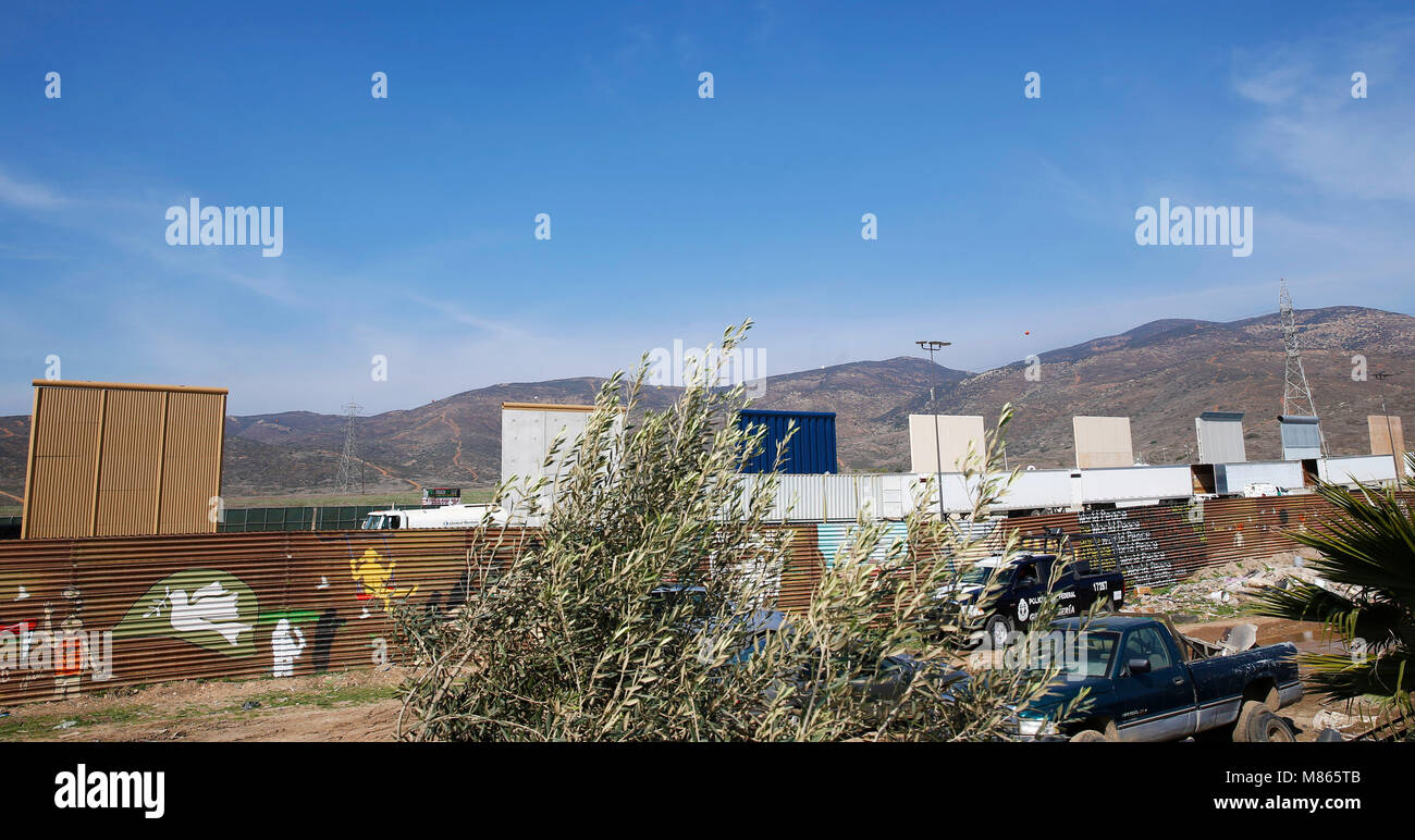 Beijing, China. 12th Mar, 2018. Border wall prototypes are seen behind ...