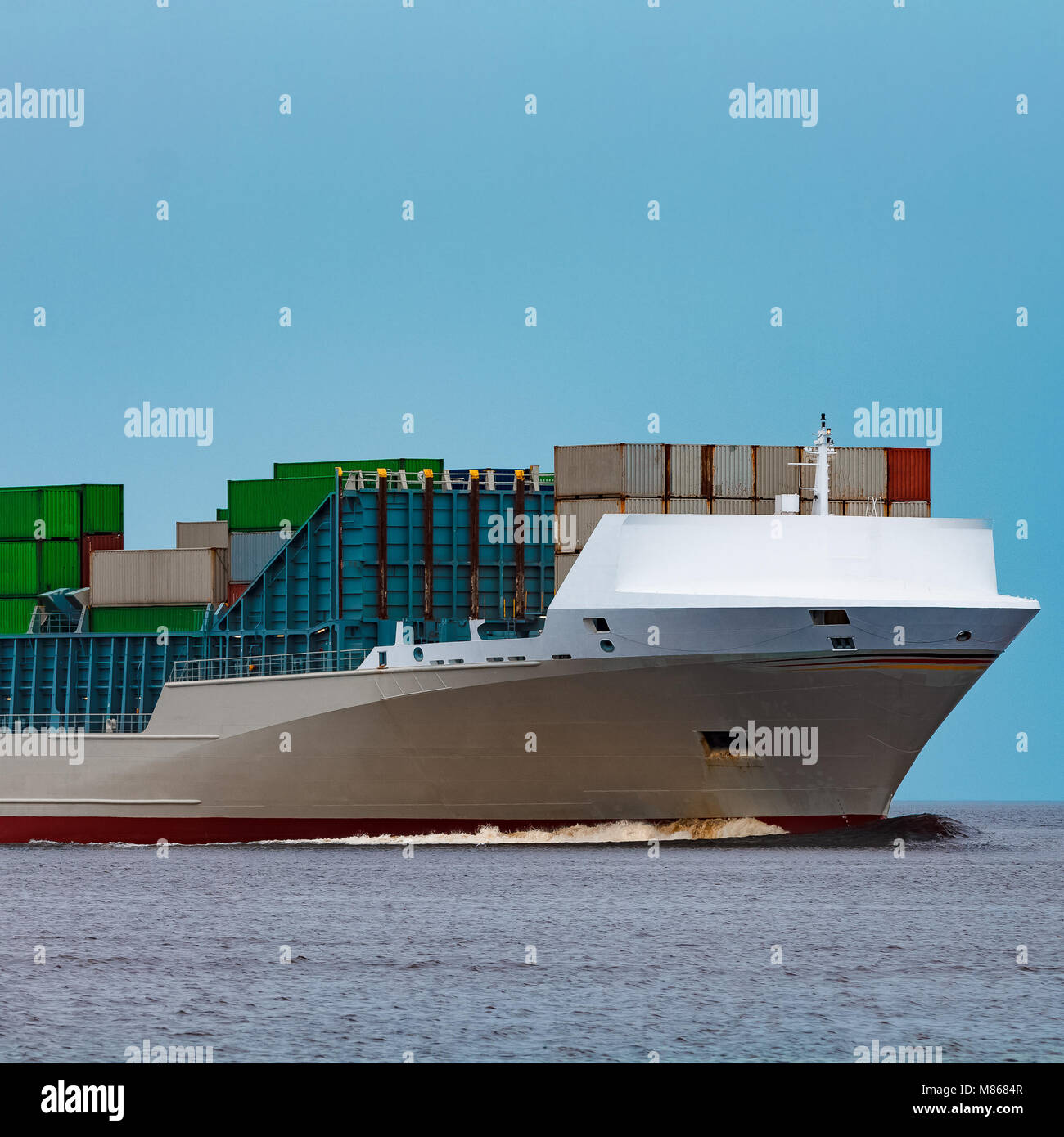 Grey container ship. Logistics and production import Stock Photo - Alamy