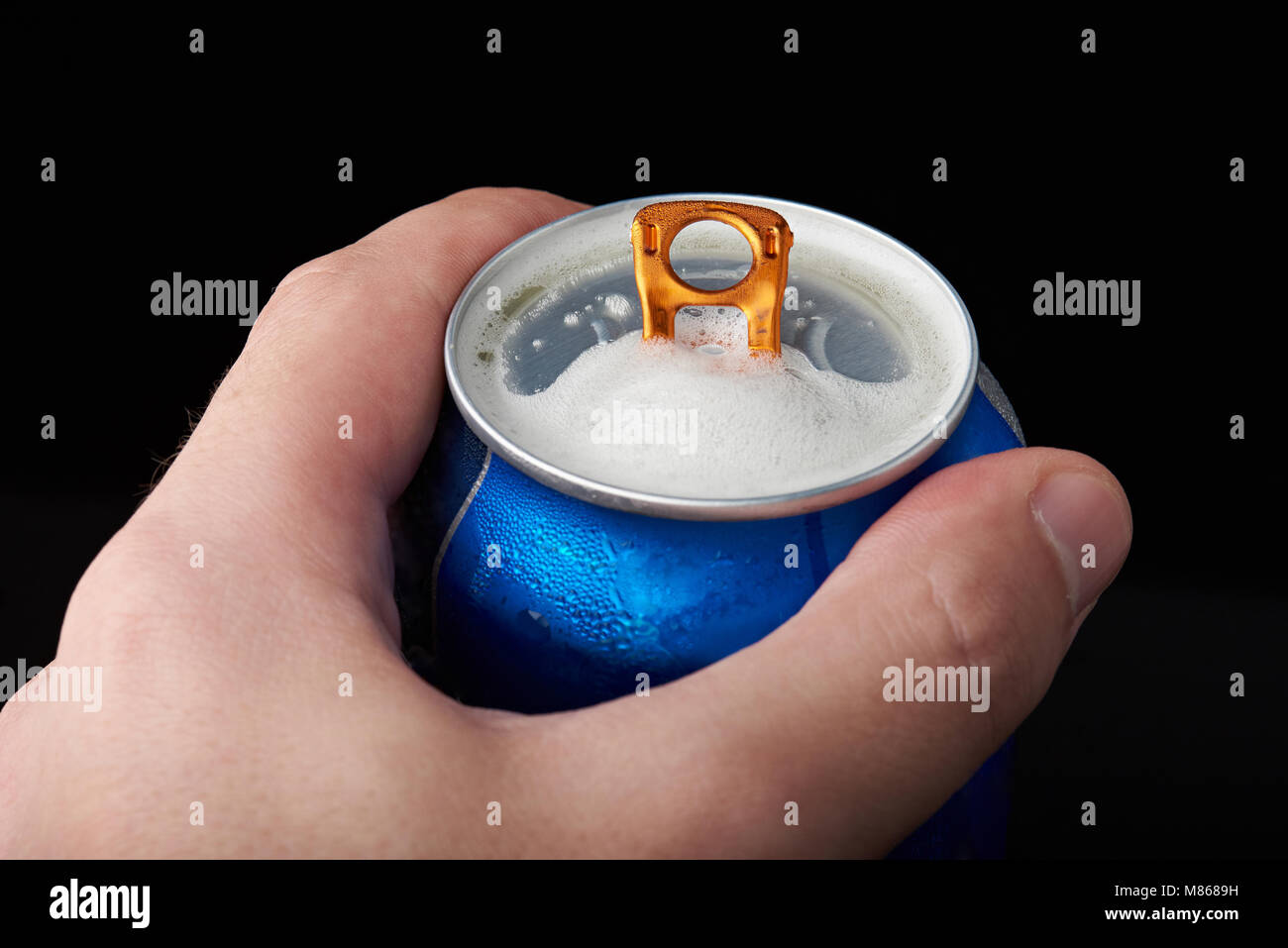 Open beer can in hand close-up isolated on black background Stock Photo ...