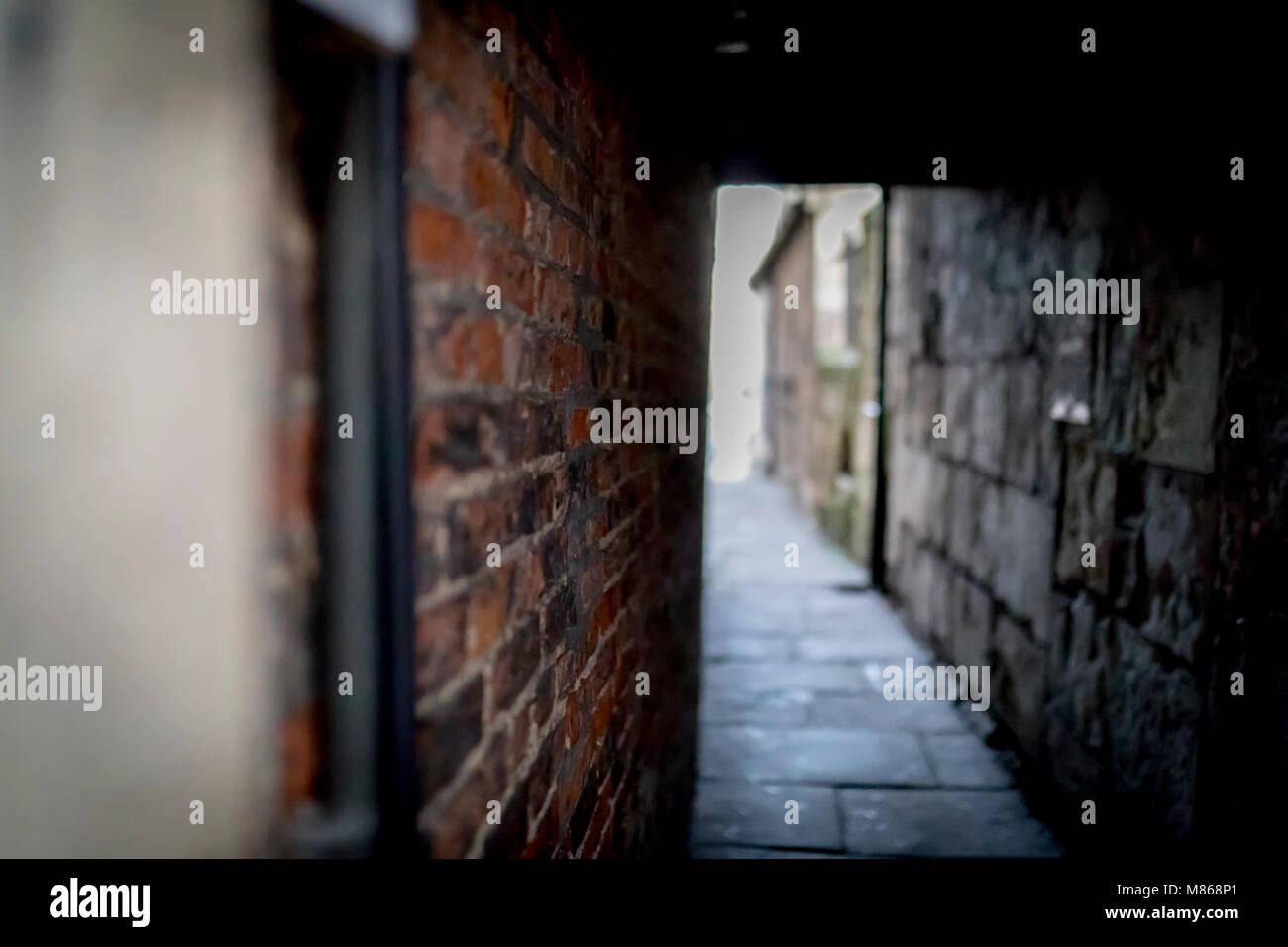 Spooky and creepy dark brick alley or hidden passage leading to the ...
