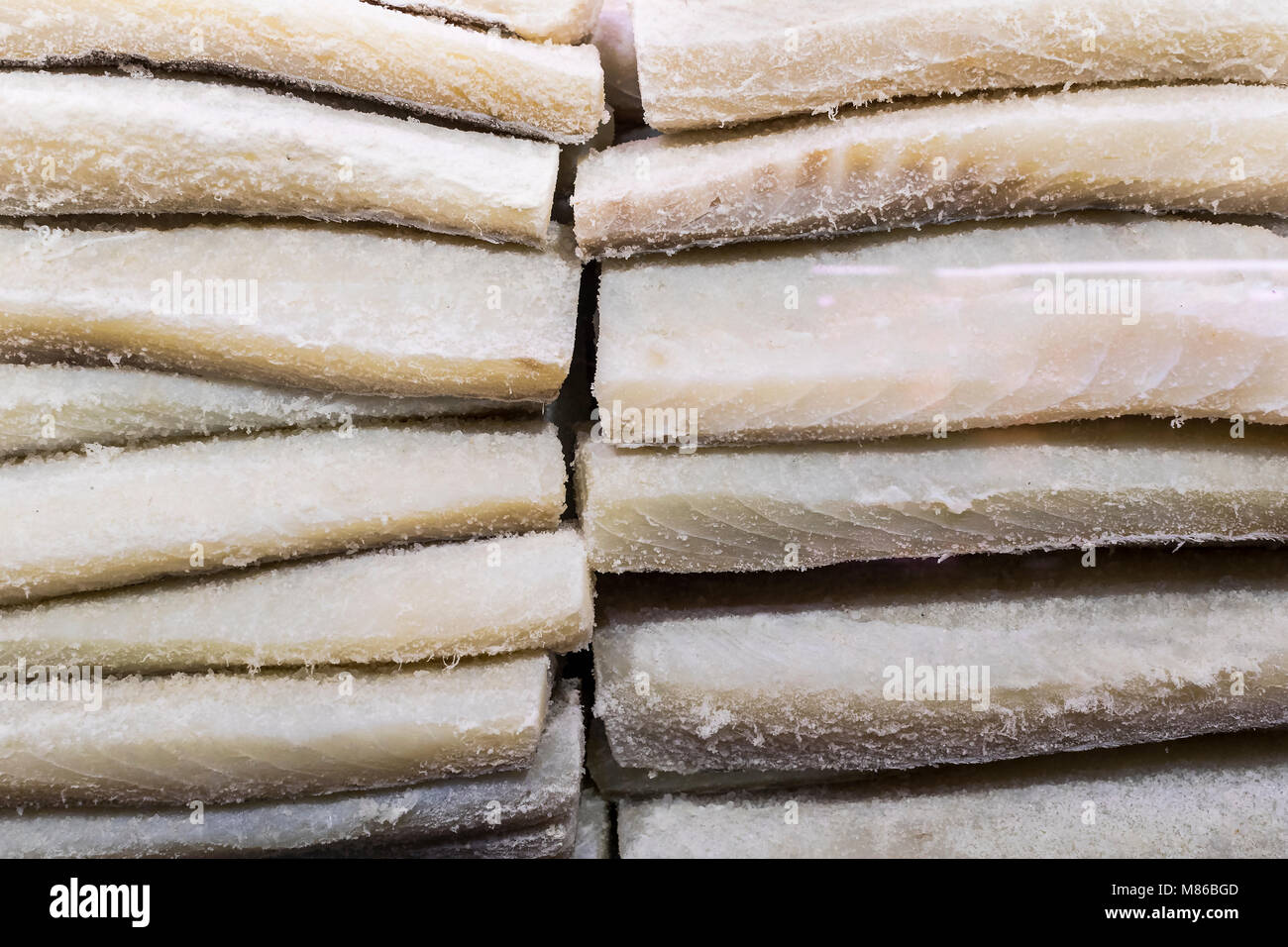 Background of frozen fish fillets of white varieties of the Atlantic ...
