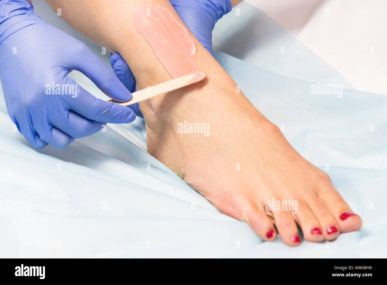 The process of classical wax depilation of female limbs in the beauty ...