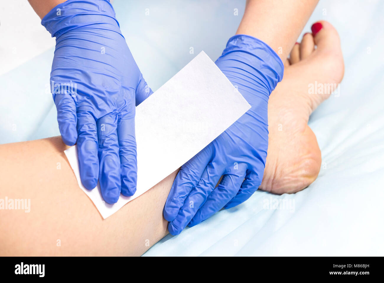 The process of classical wax depilation of female limbs in the beauty ...