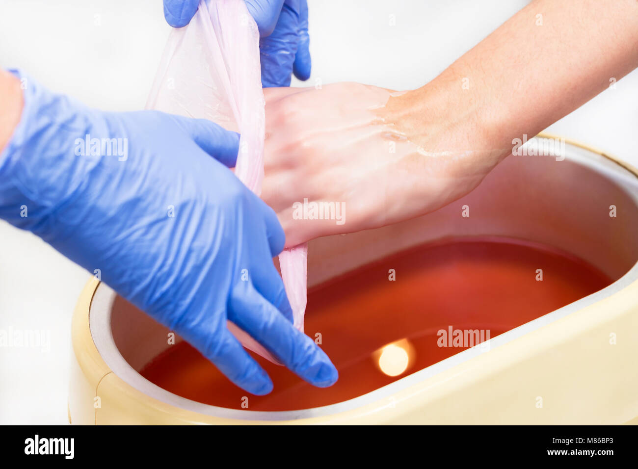 Process paraffin treatment of female hands in beauty salon Stock Photo ...