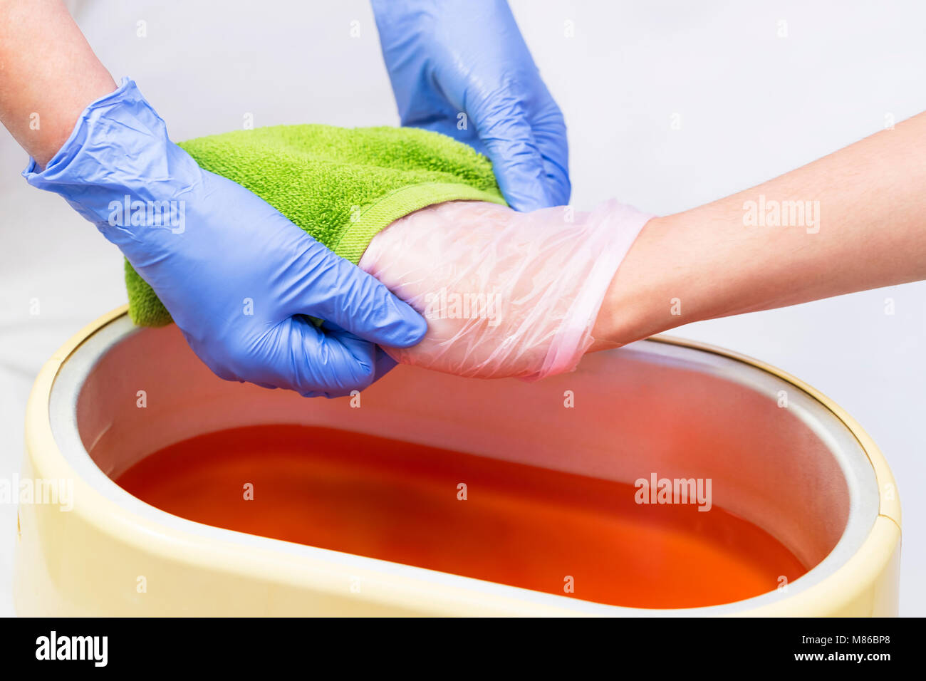 Process paraffin treatment of female hands in beauty salon Stock Photo ...