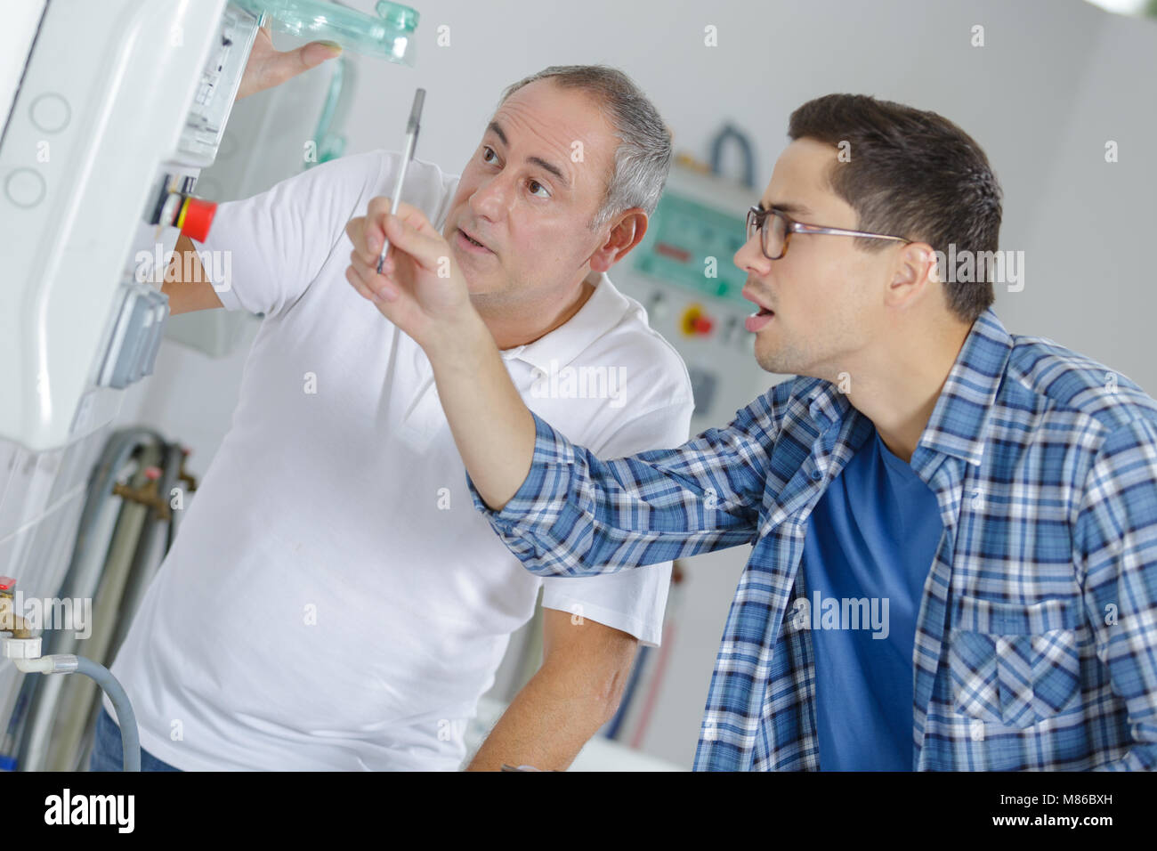 Men checking hospital equipment Stock Photo - Alamy