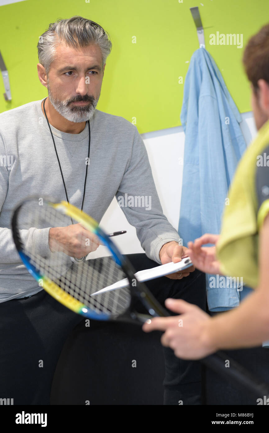 professional tennis trainer talking to tenis player Stock Photo - Alamy