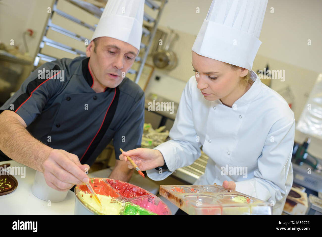 Chefs decorating product Stock Photo - Alamy