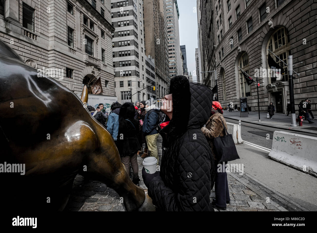 The Charging Bull Statue surrounded by tourists in the Financial ...