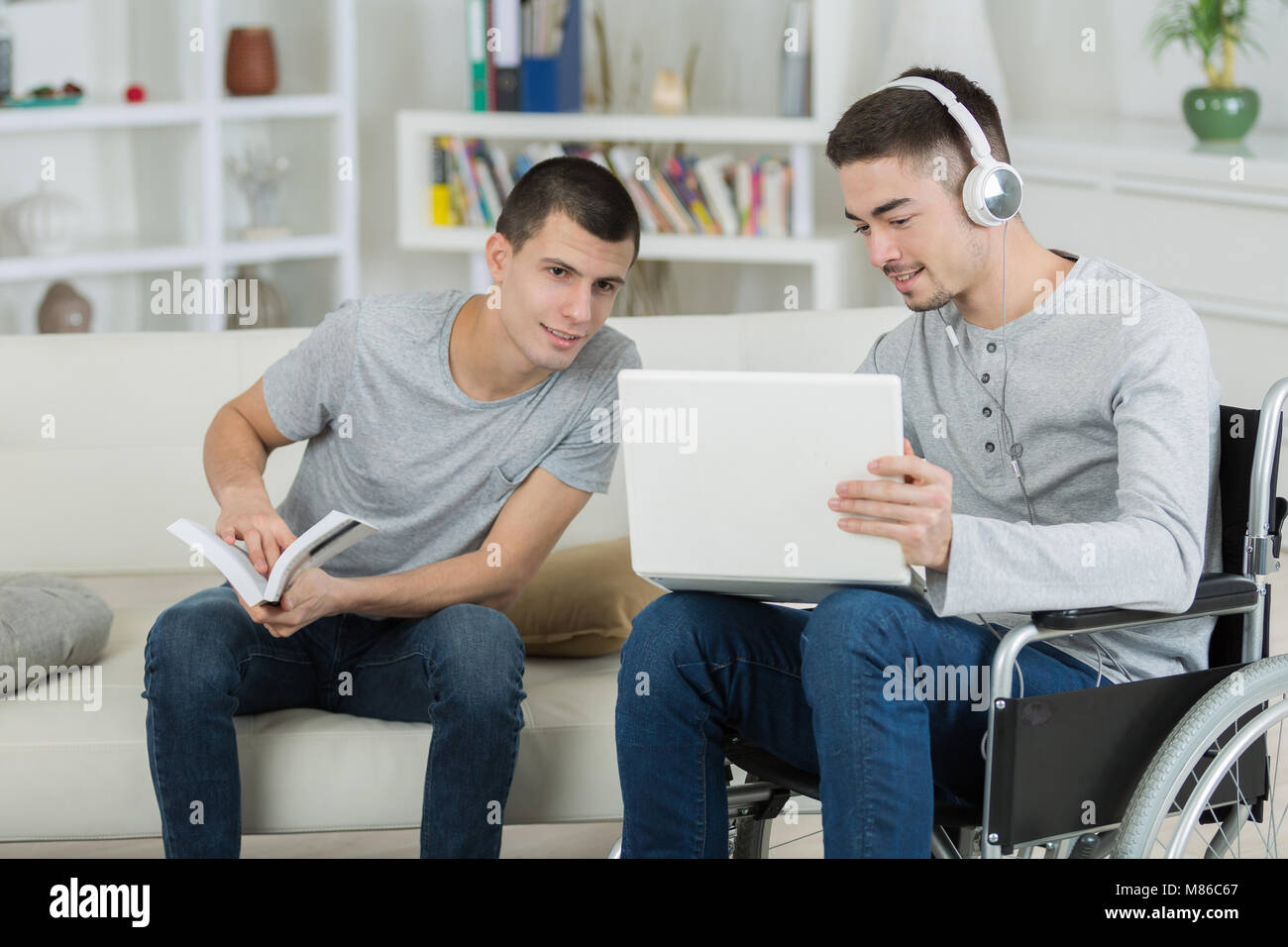 two male students going over their homework Stock Photo - Alamy