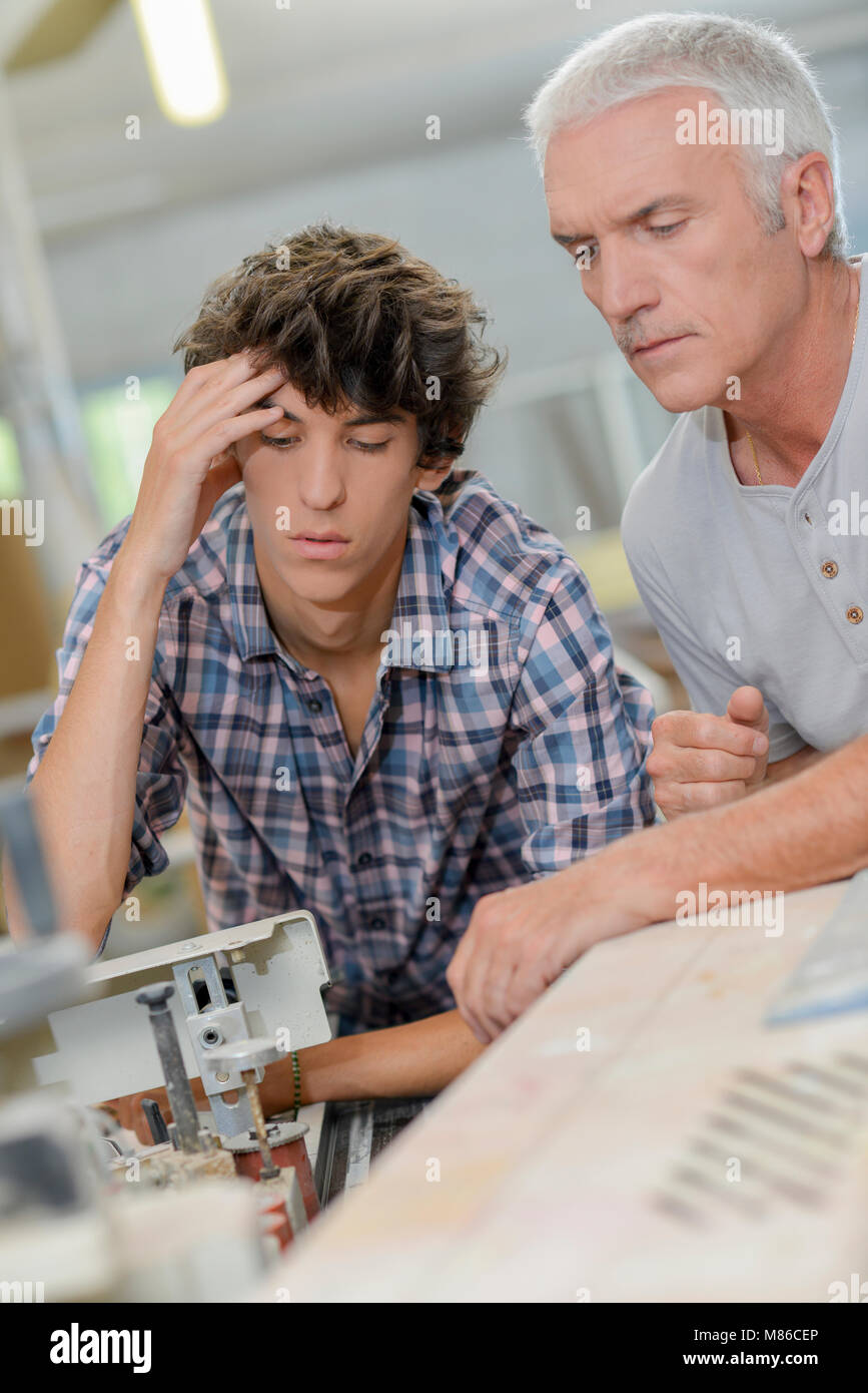 Teenager helping his carpenter dad Stock Photo - Alamy