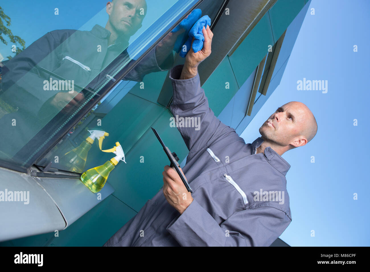 man cleaning window in office Stock Photo - Alamy