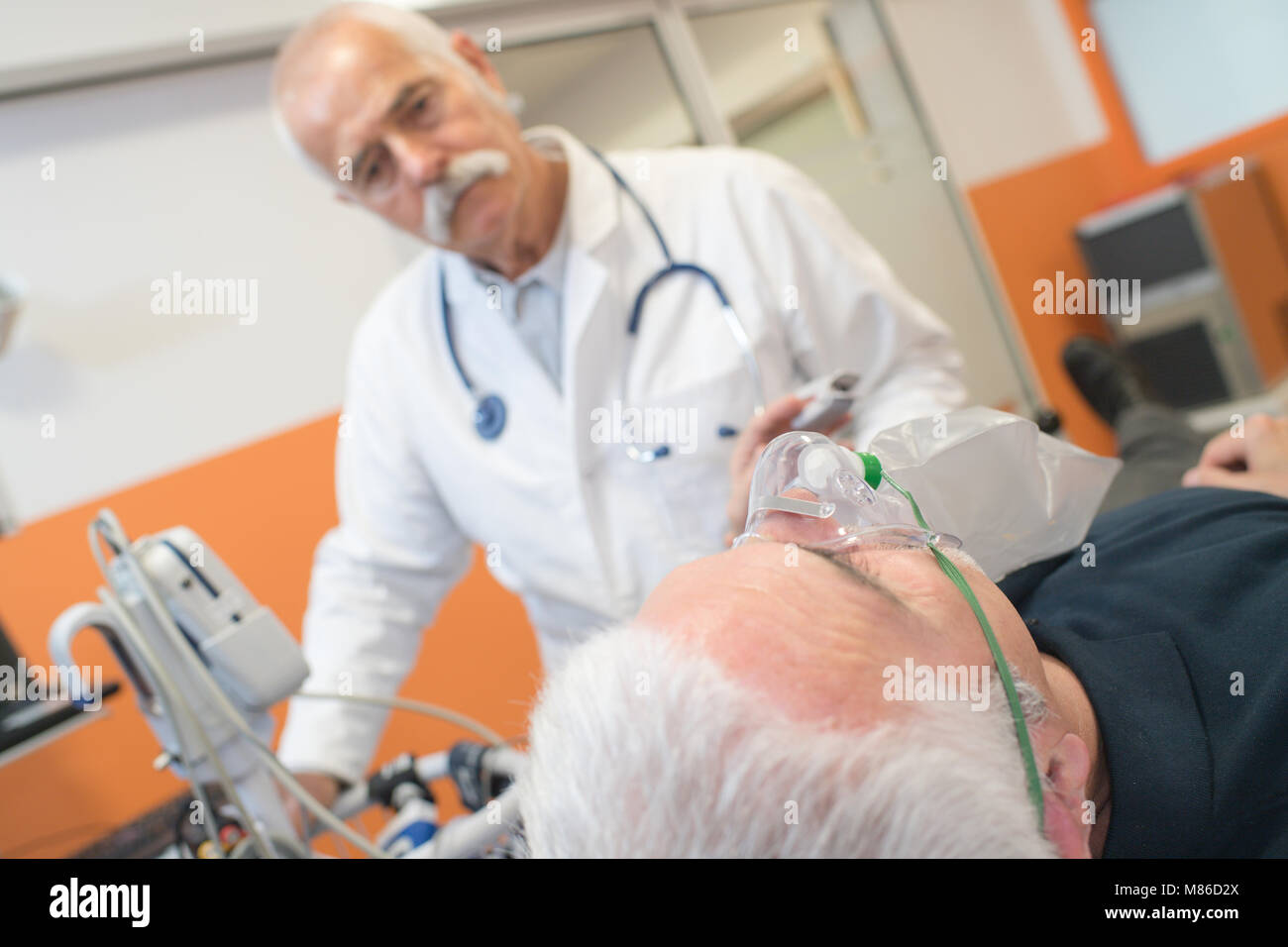 doctor examining the patient wearing breathing mask Stock Photo - Alamy
