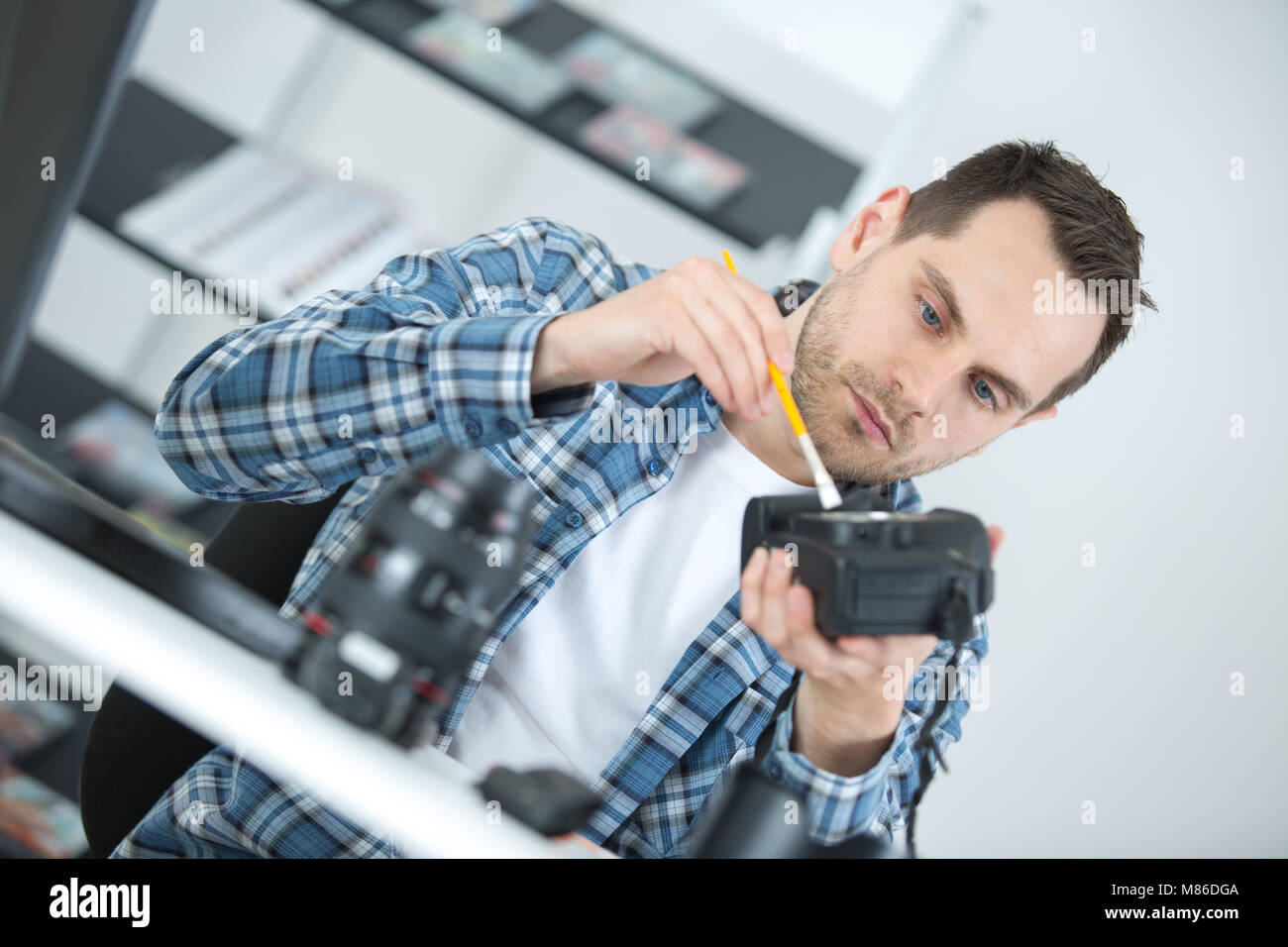 man cleaning lens of his digital camera with special brush Stock Photo ...