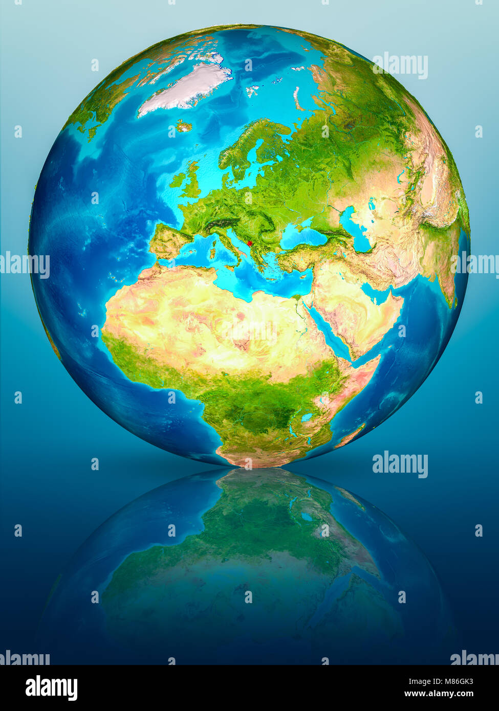 Montenegro in red on model of planet Earth on reflective blue surface ...