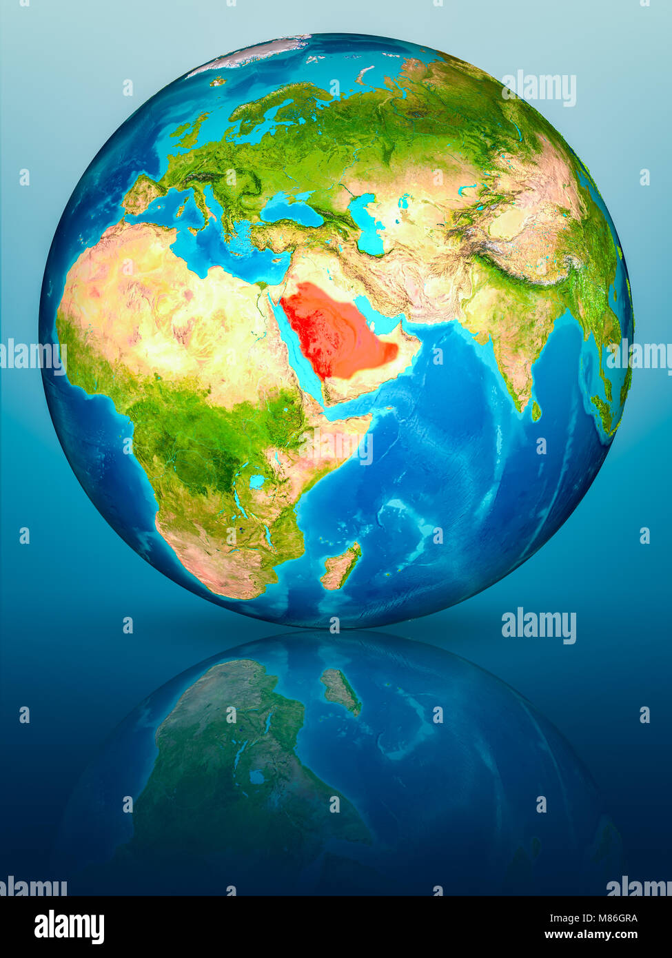 Saudi Arabia in red on model of planet Earth on reflective blue surface ...