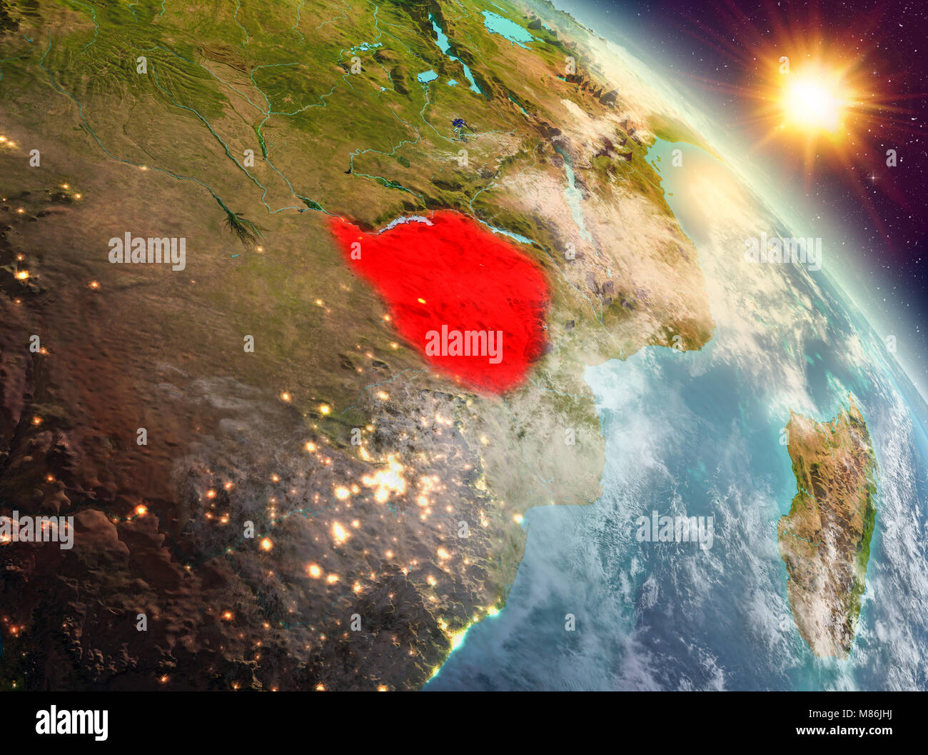 Sunrise above Zimbabwe highlighted in red on model of planet Earth in ...