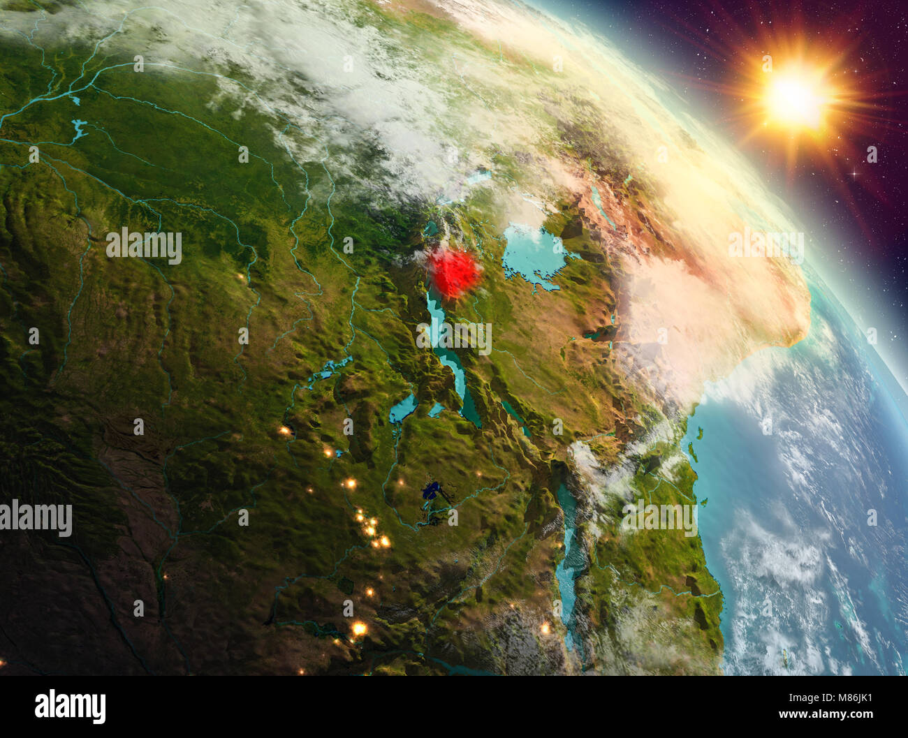 Sunrise above Burundi highlighted in red on model of planet Earth in space. 3D illustration ...