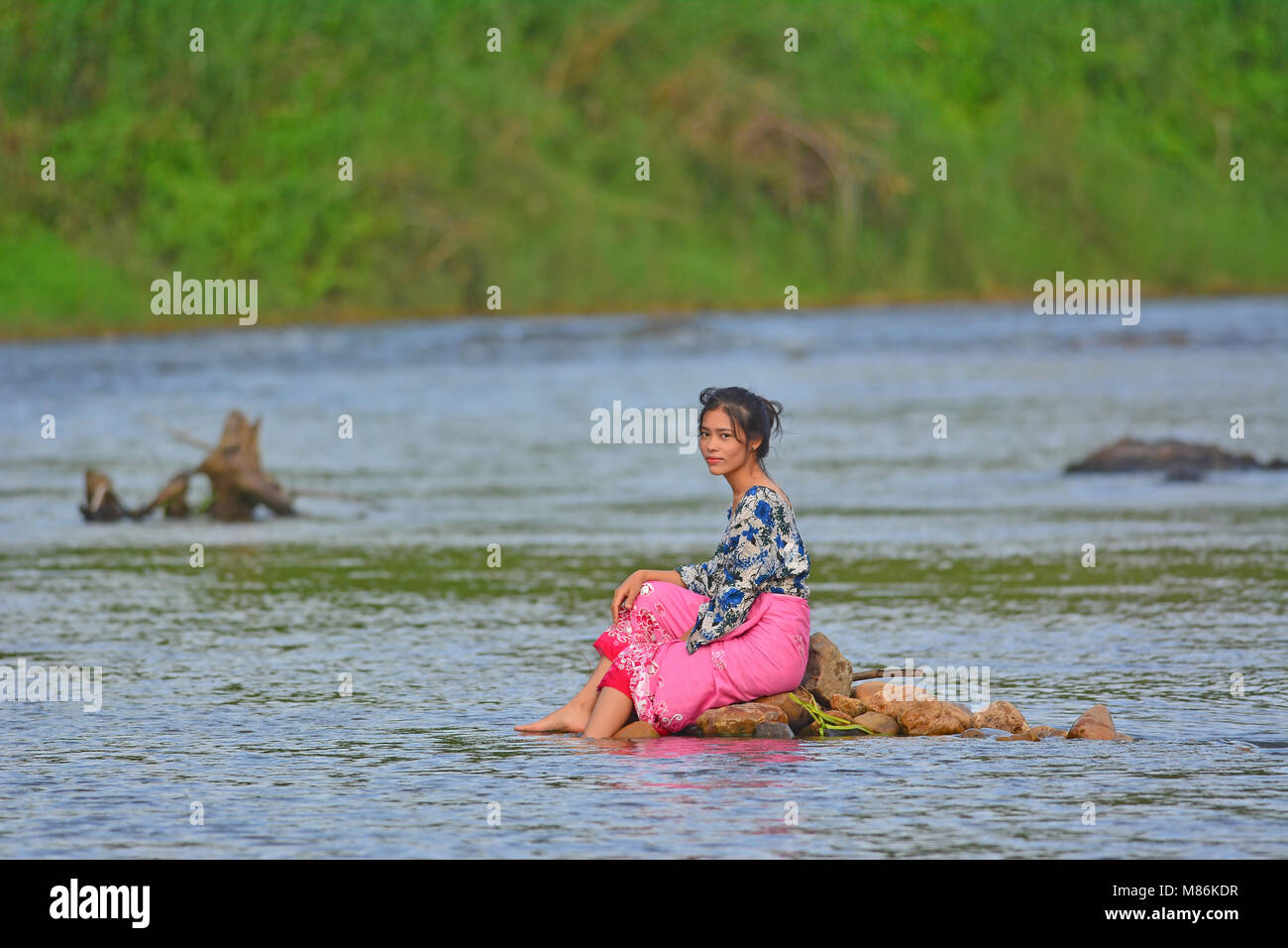 Portrait of young girl in river, Young girl posing on the water Stock ...
